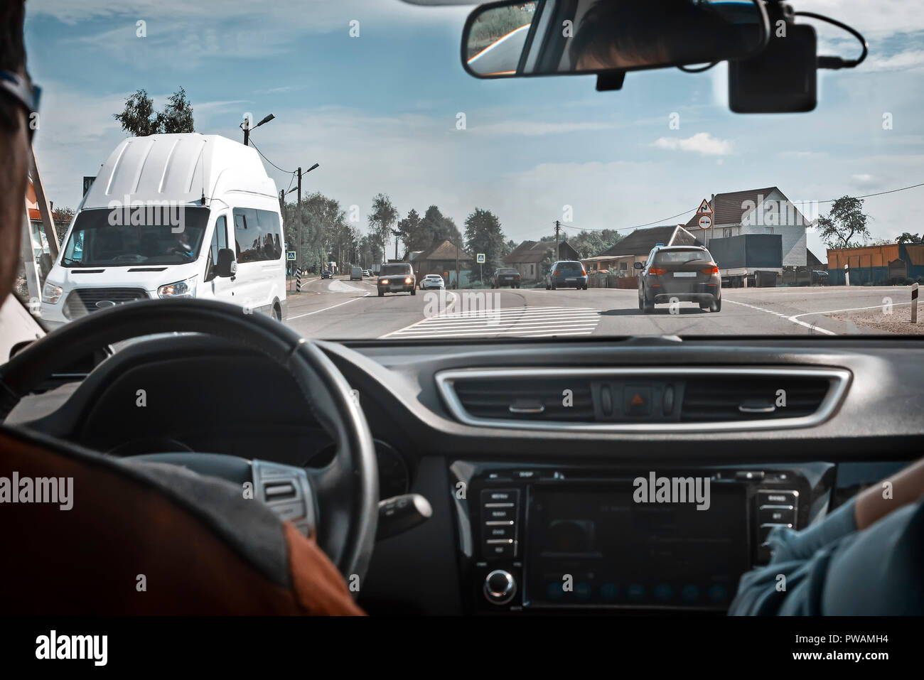 From the front window of the car is visible wide road with two-way ...