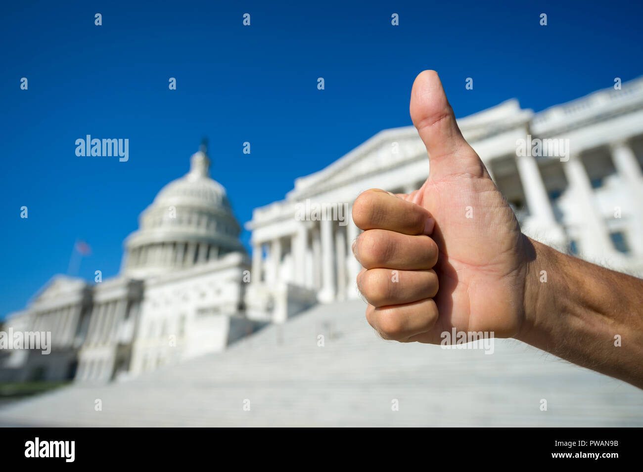 Thumbs up hand in front of the Capitol Building in Washington, DC, USA ...
