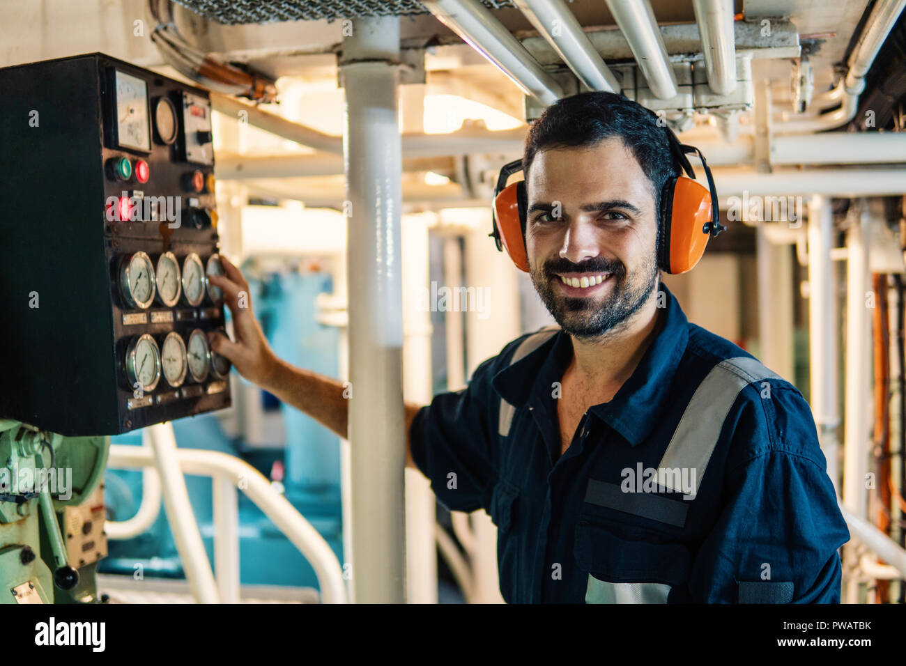Marine engineer officer working in engine room Stock Photo - Alamy