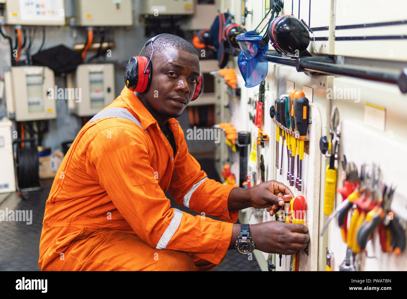 Marine engineer officer working in engine room Stock Photo - Alamy