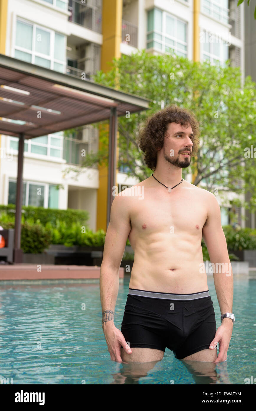 Handsome bearded man shirtless relaxing beside the swimming pool Stock ...