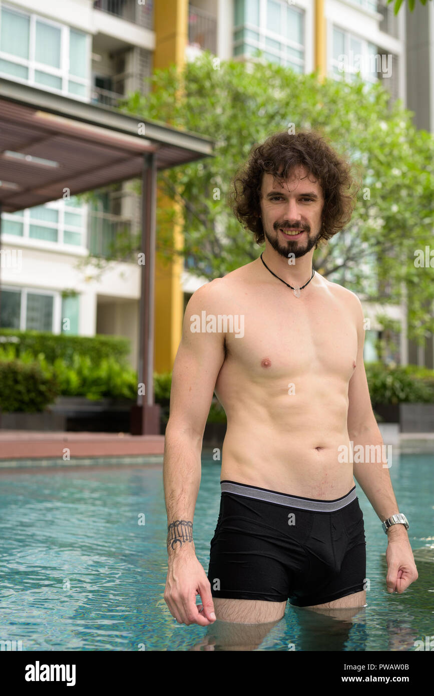Handsome bearded man shirtless relaxing beside the swimming pool Stock ...
