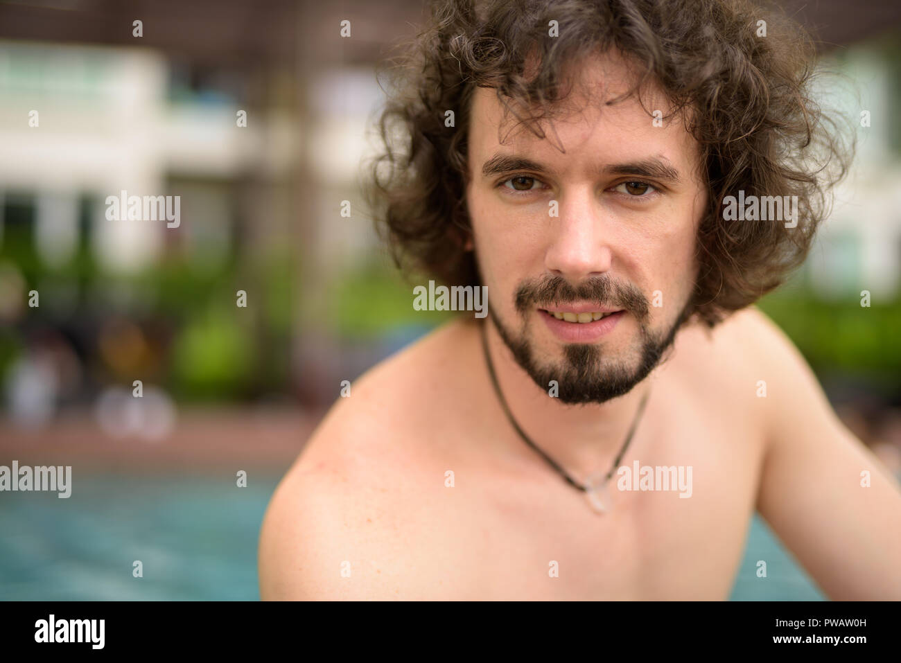 Handsome bearded man shirtless relaxing beside the swimming pool Stock ...