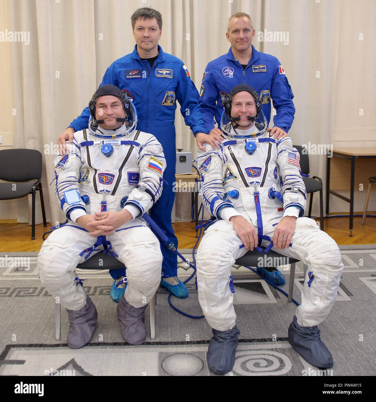 Expedition 57 Flight Engineer Alexey Ovchinin of Roscosmos, seated left ...