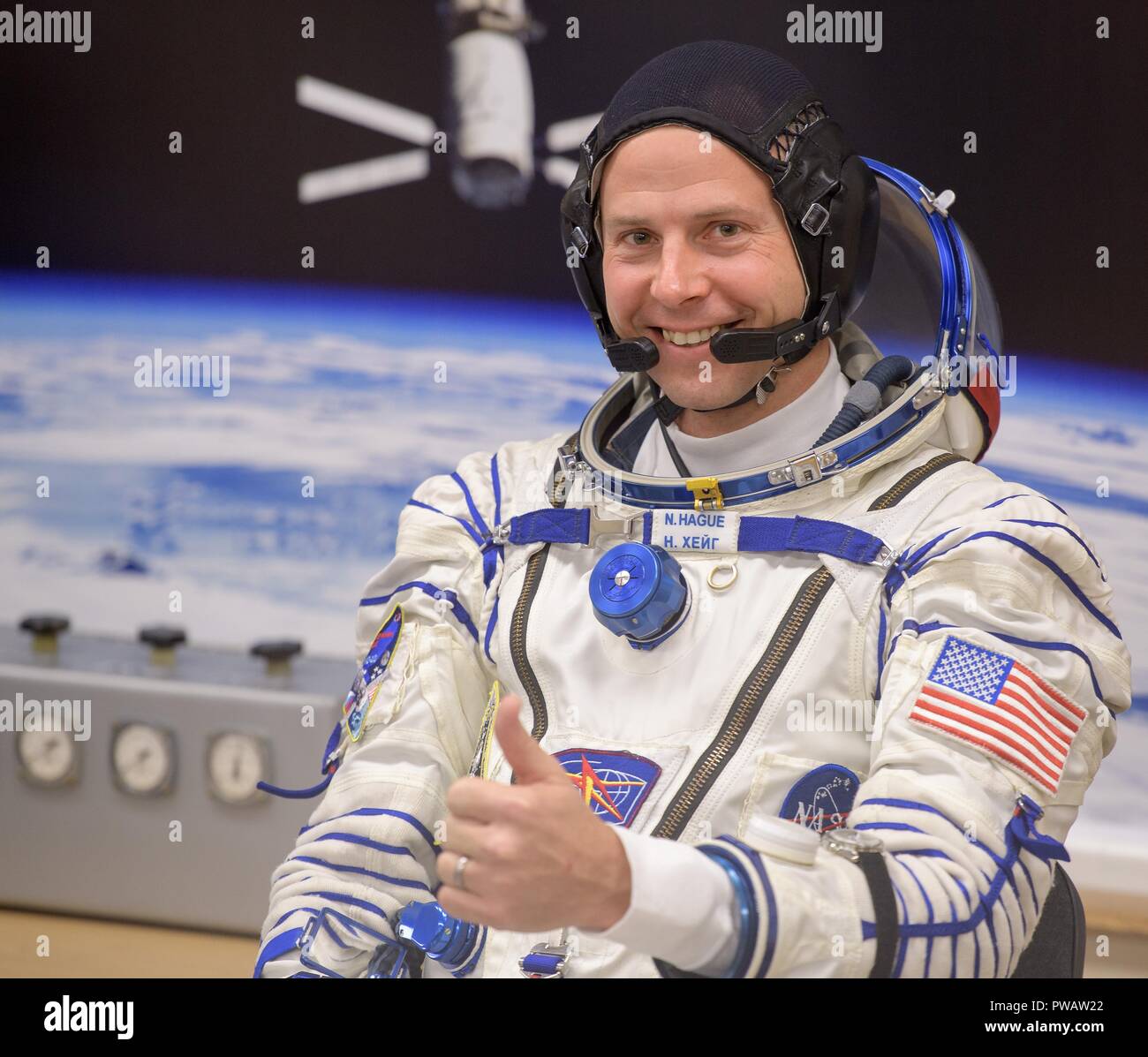 Expedition 57 Flight Engineer Nick Hague of NASA gives a thumbs up as ...