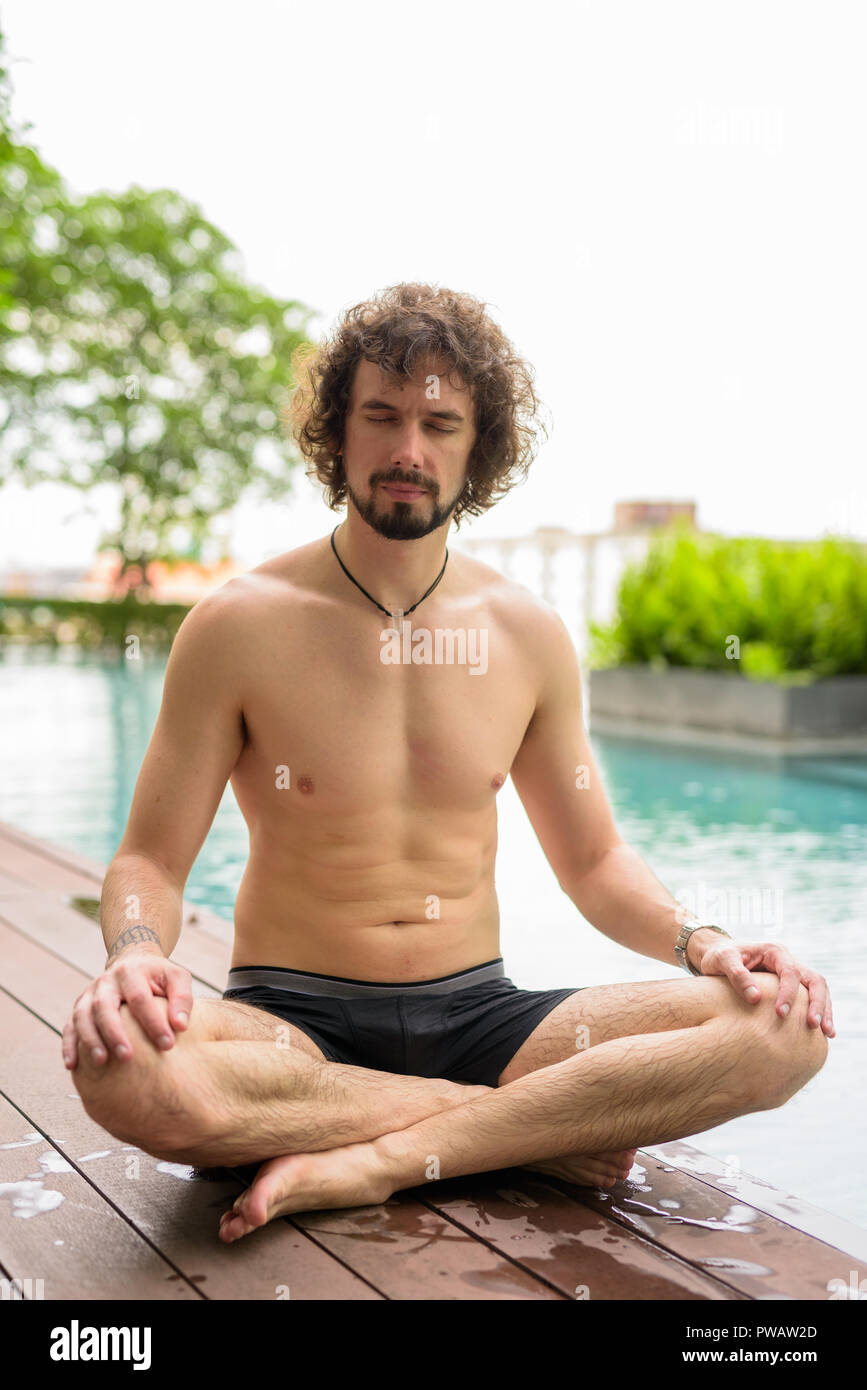 Handsome bearded man shirtless relaxing beside the swimming pool Stock ...