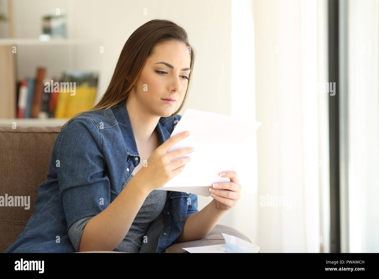 Woman In Blue Reading A Letter