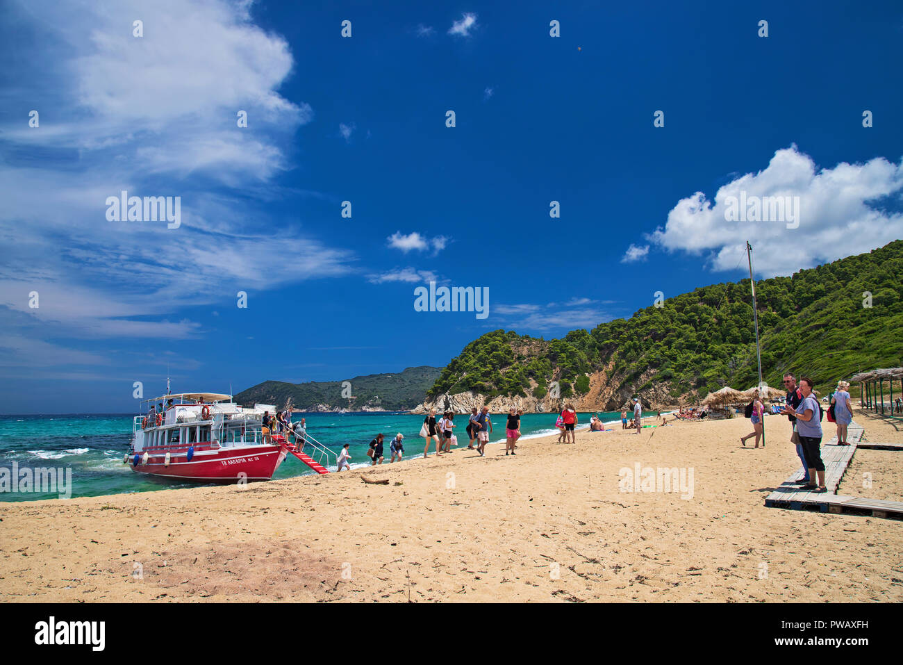 Tourist boat arriving at Megalos Aselinos beach, at the north coast of ...