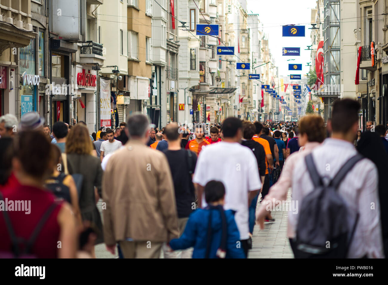 A busy street view of Istikal street with people walking past a long ...