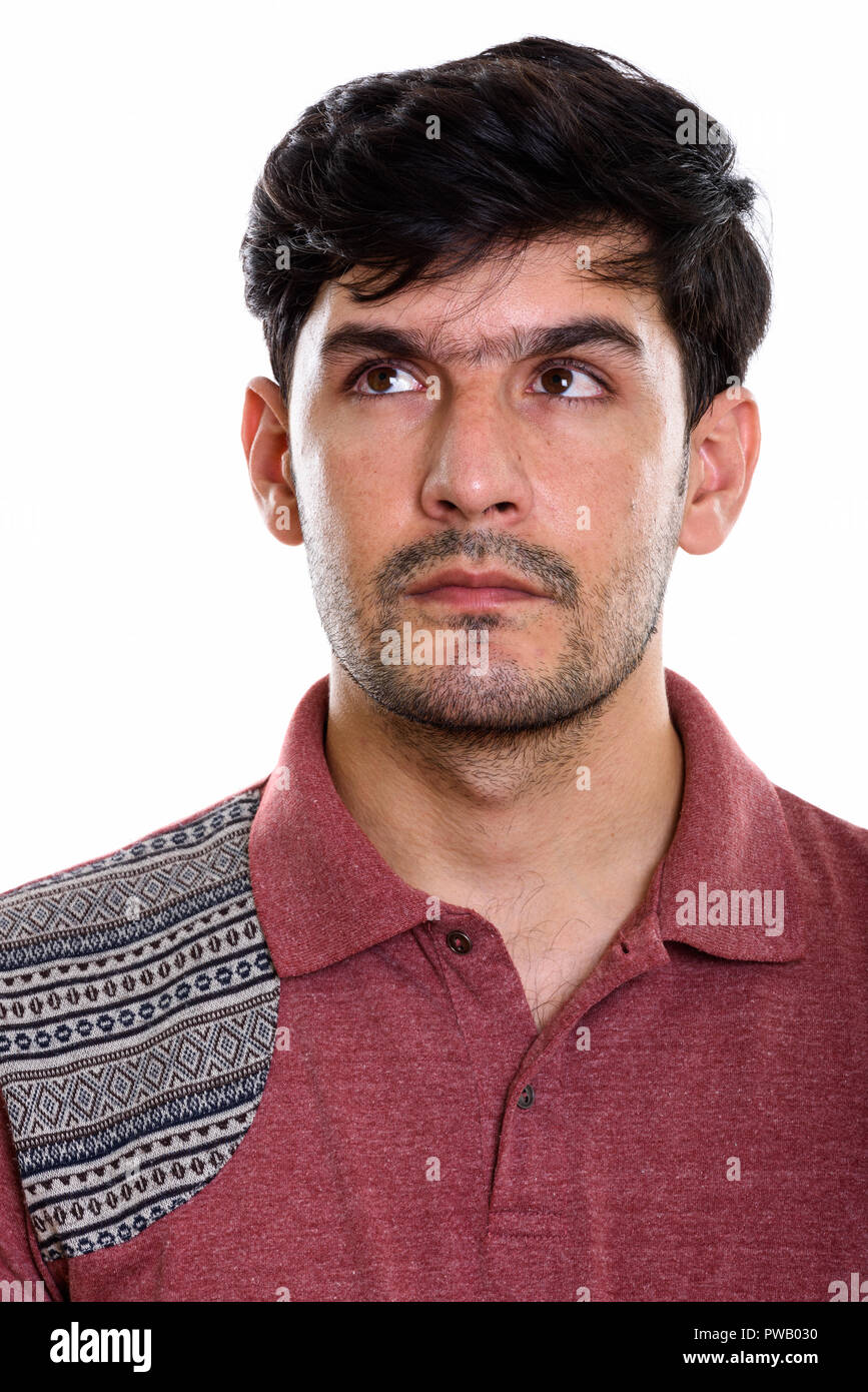 Face of young Persian man thinking while looking up Stock Photo - Alamy