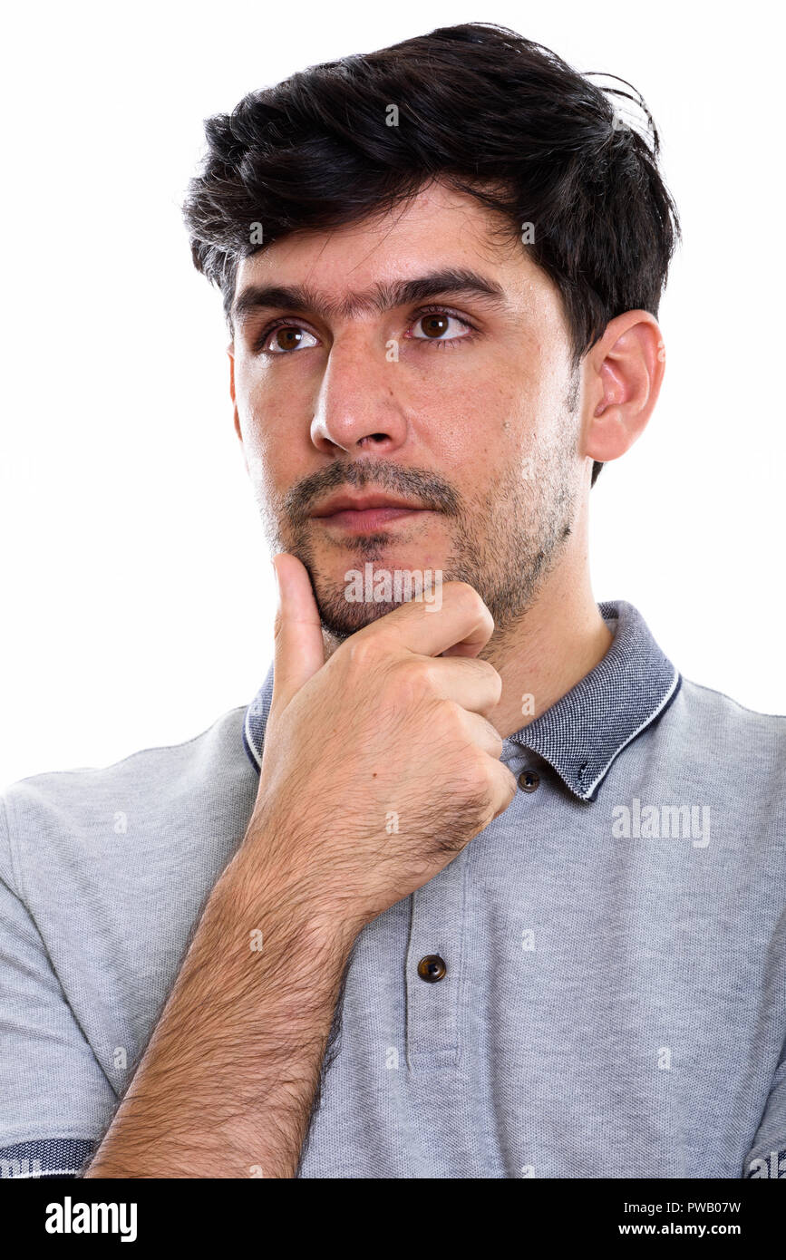 Face of young Persian man thinking while looking up Stock Photo - Alamy
