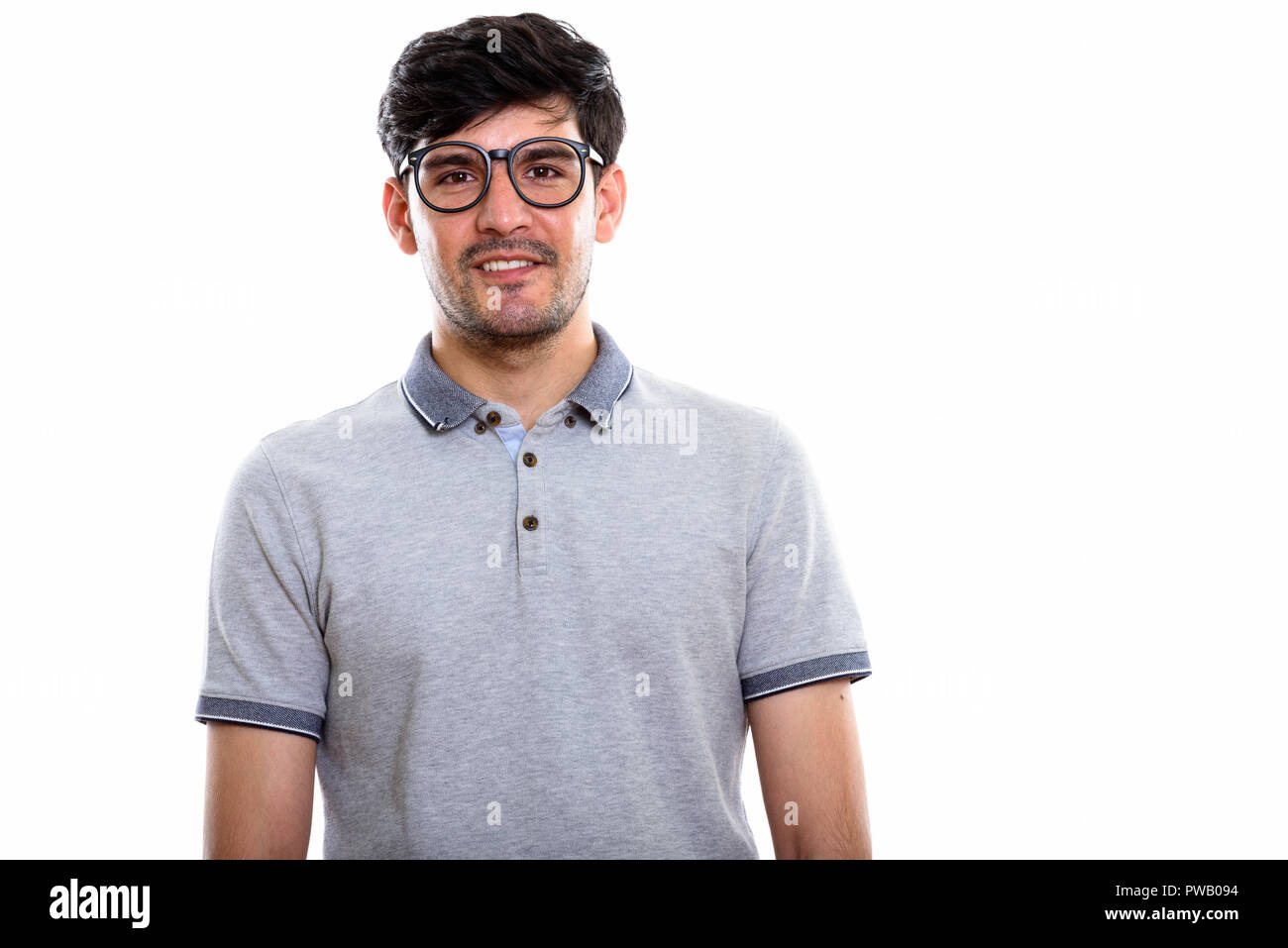 Studio shot of young happy Persian man smiling while wearing eye Stock ...