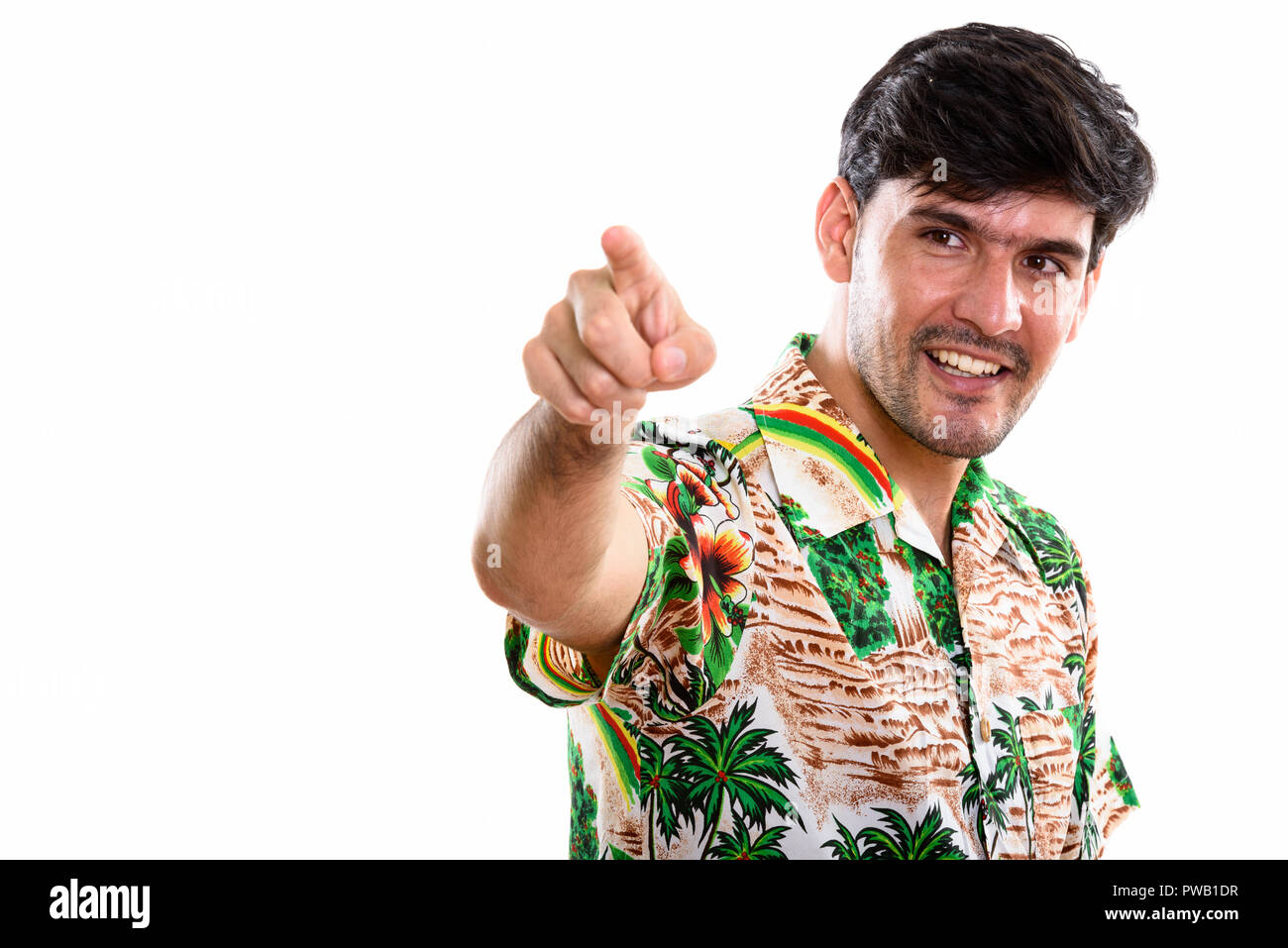 Thoughtful young happy Persian man smiling while pointing finger Stock ...