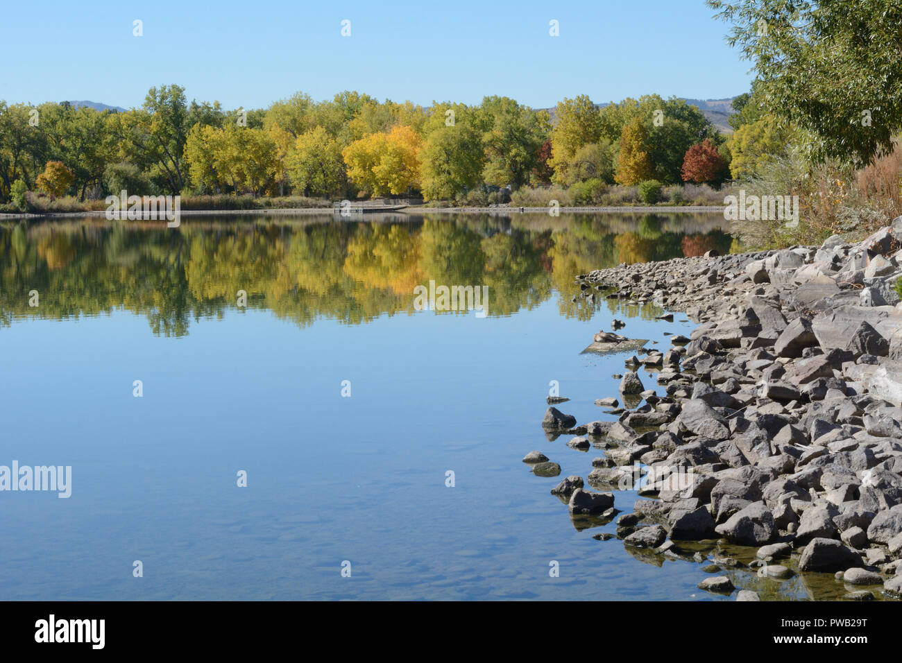 Colorado Front Range lake landscape with autumn trees with reflection ...