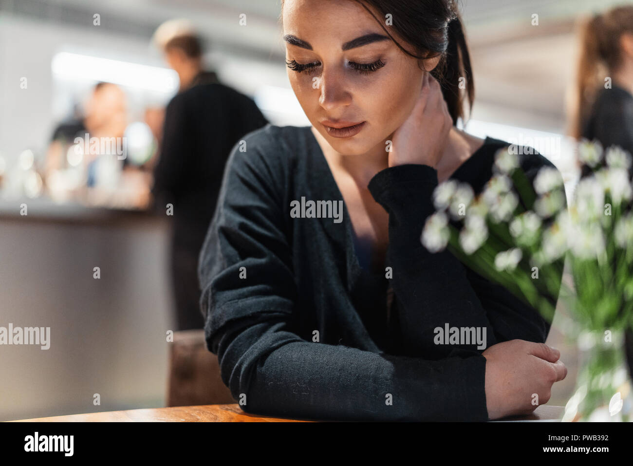 Young beautiful woman looking at menu deciding what to order in modern ...