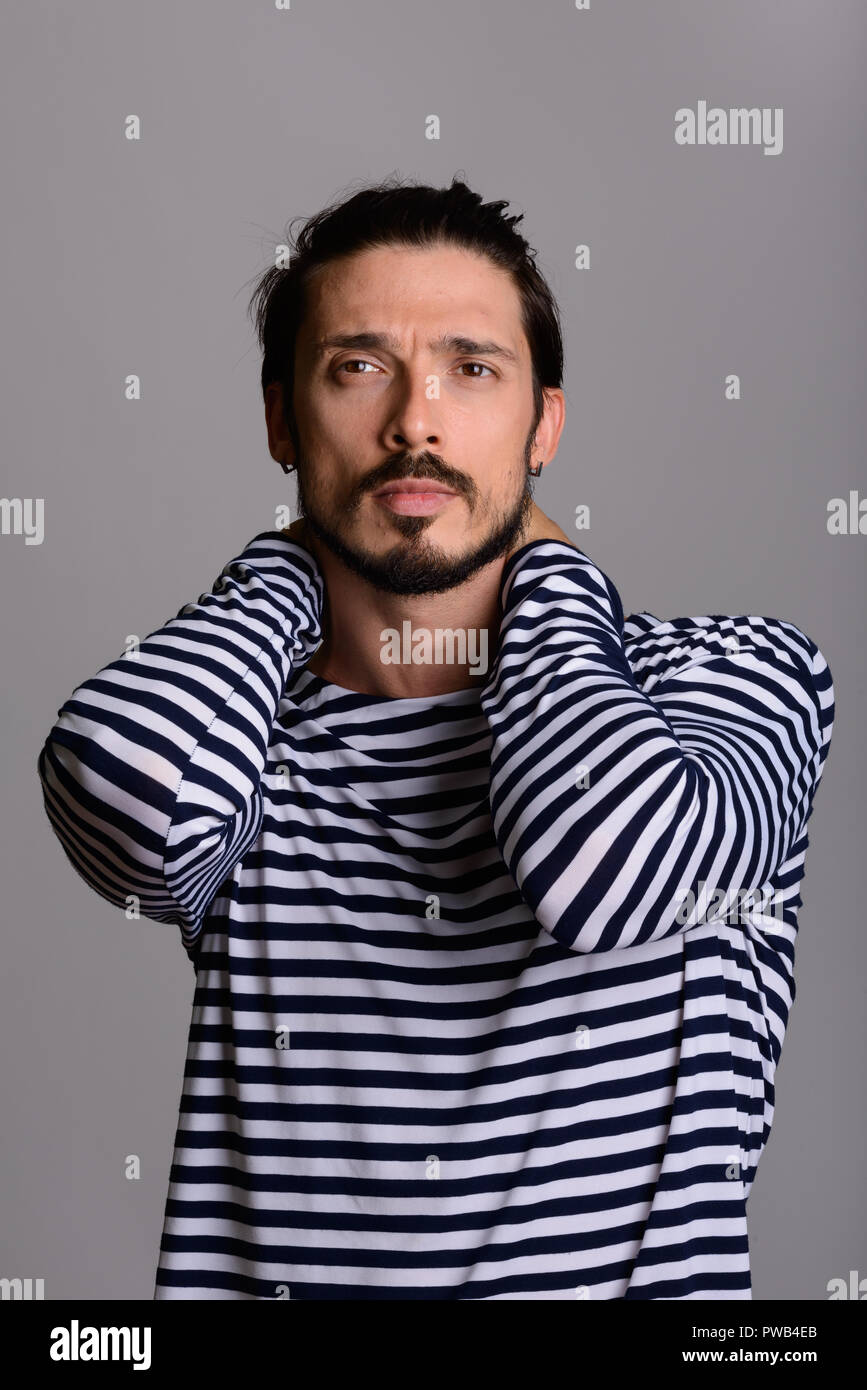 Studio shot of handsome man thinking while posing Stock Photo - Alamy
