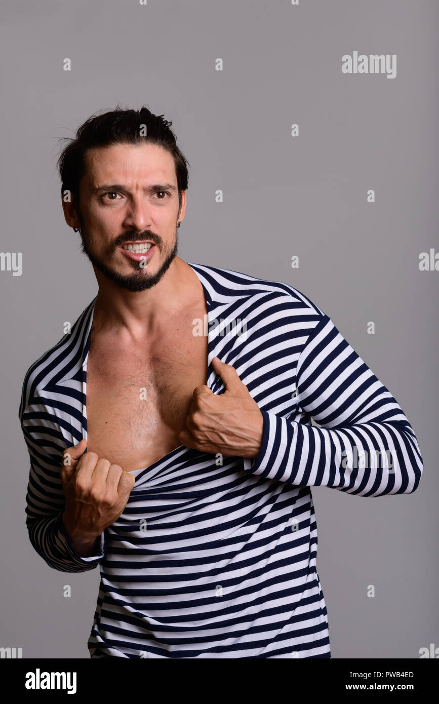 Studio shot of handsome man showing chest Stock Photo - Alamy