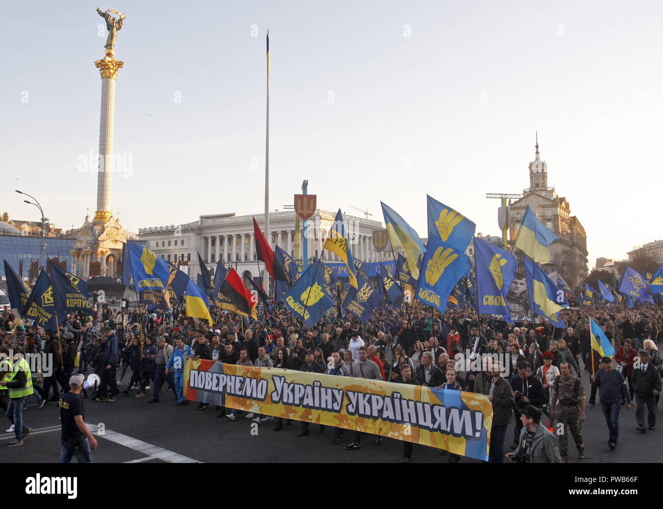 Kiev, Ukraine. 14th Oct, 2018. People seen marching with banners and ...