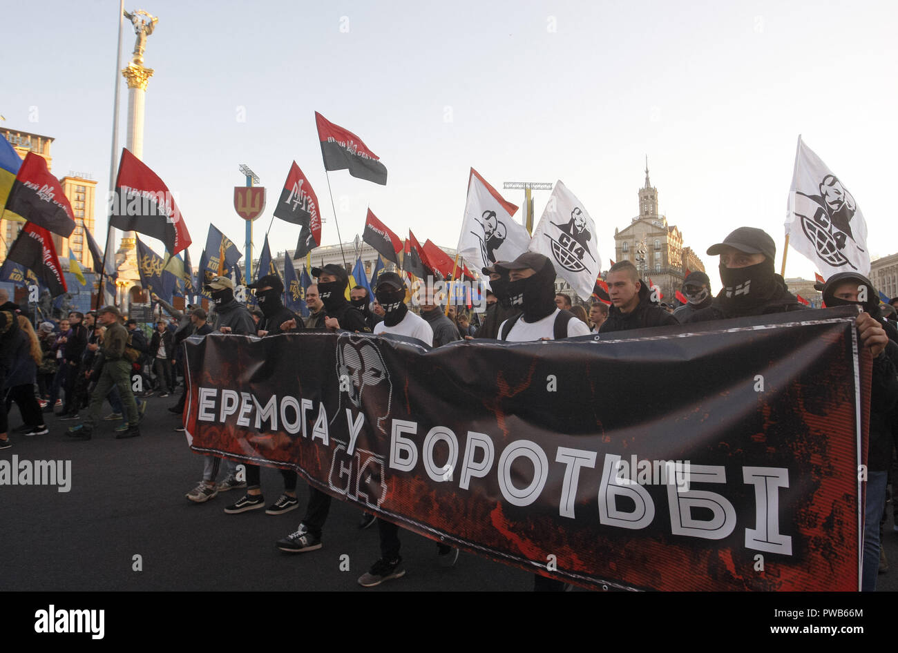 Kiev, Ukraine. 14th Oct, 2018. People seen marching with a banner and ...