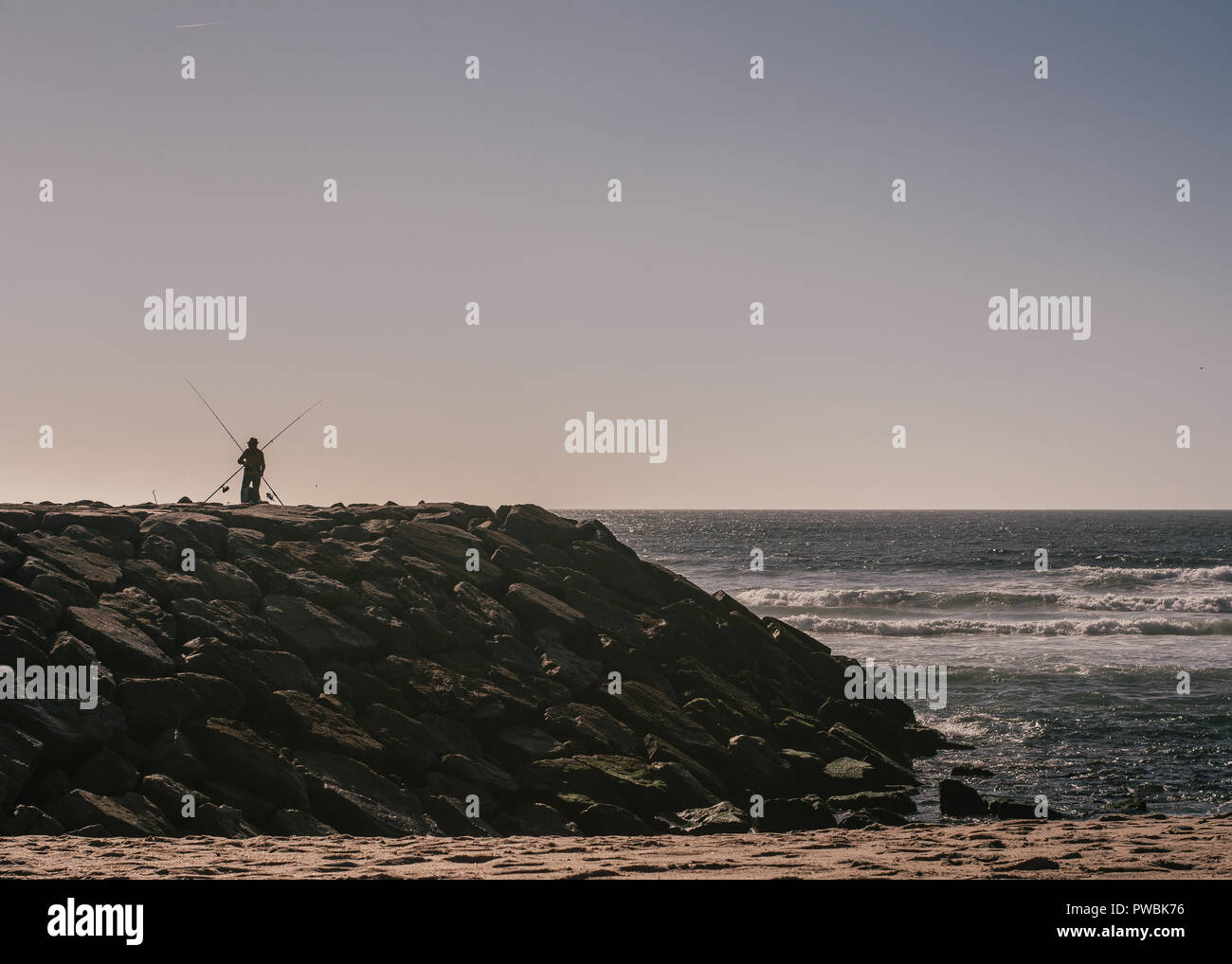 Fisherman at ocean coast Stock Photo - Alamy