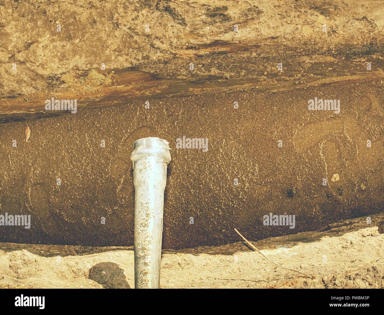 Repairing of plastic tube water delivery system. Open trench with small ...