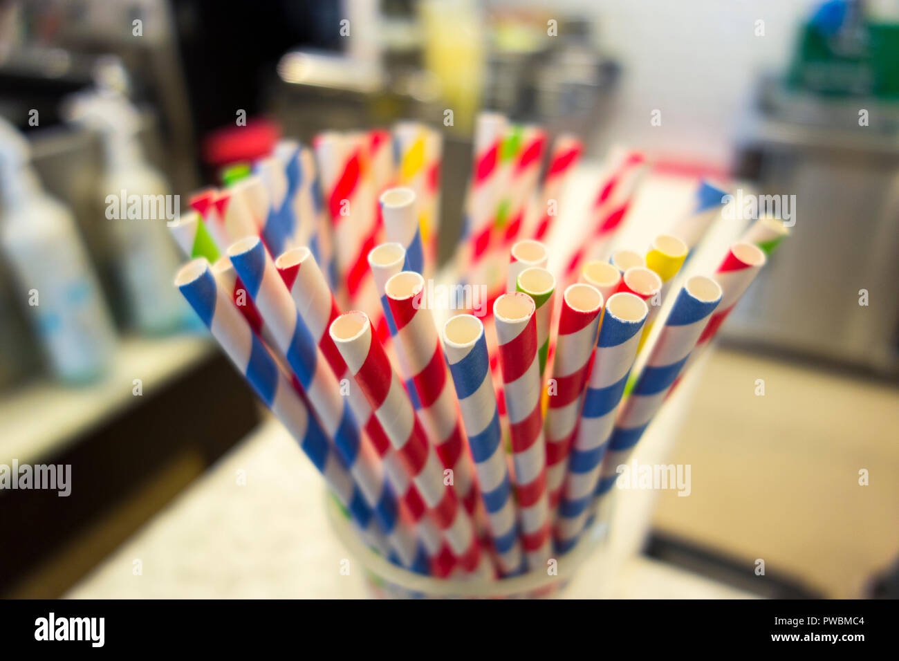 Colorful biodegradable and compostable paper straws in a cafe in London ...