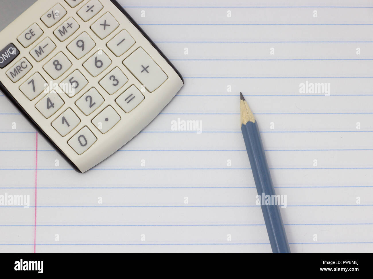 Close-up. Gray pencil and calculator on white background, back to ...