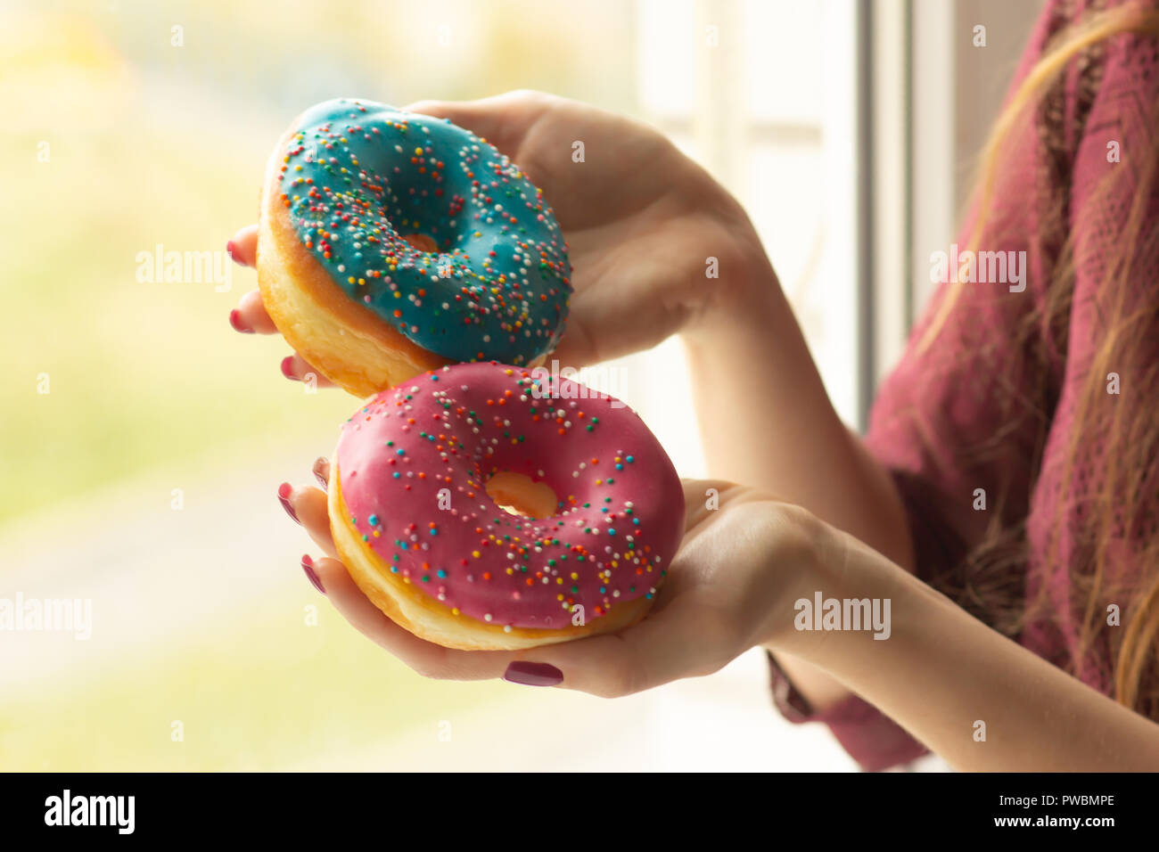 Holding up donuts hi-res stock photography and images - Alamy
