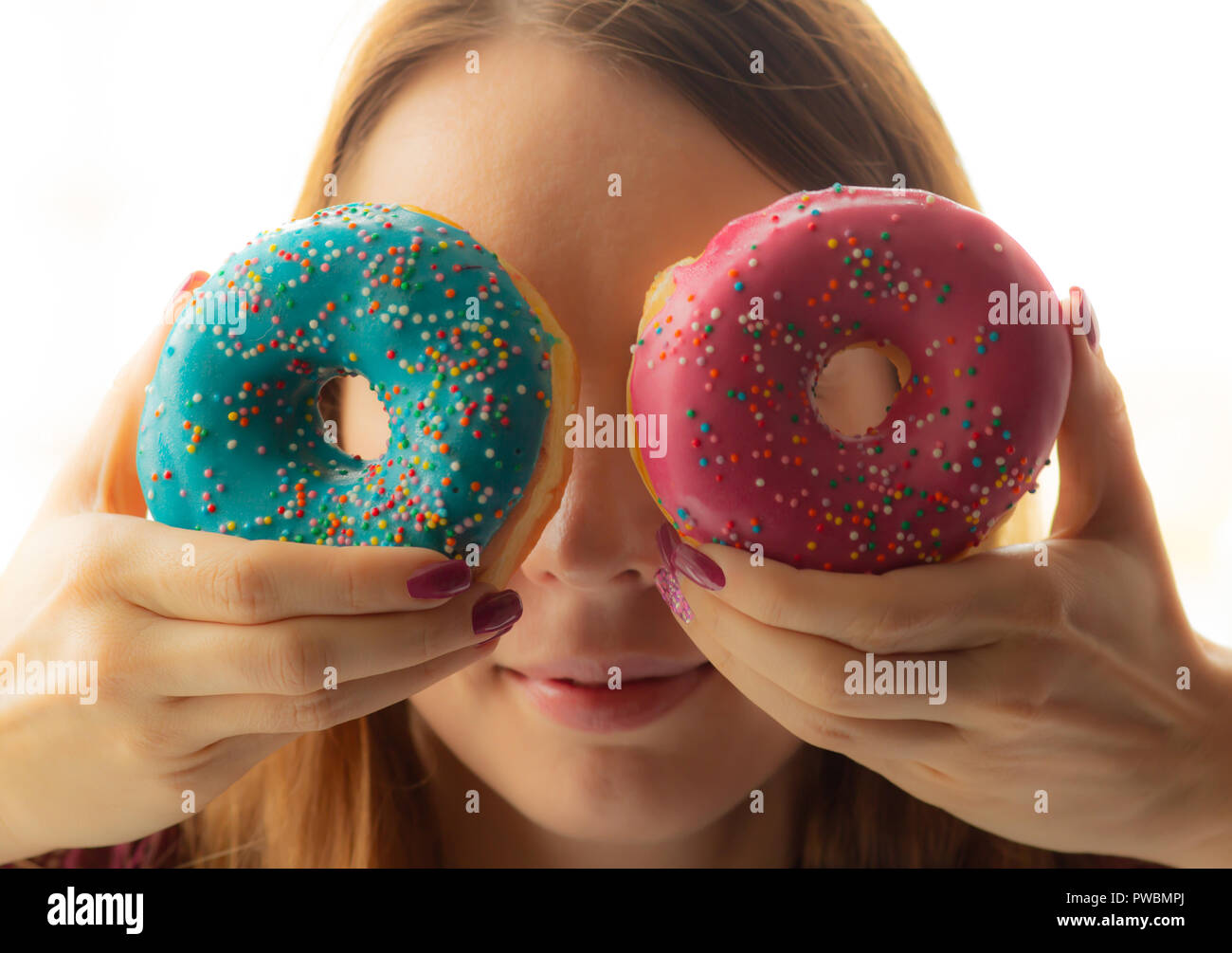 The eye of the donuts. Girl with the donuts on white background Stock ...