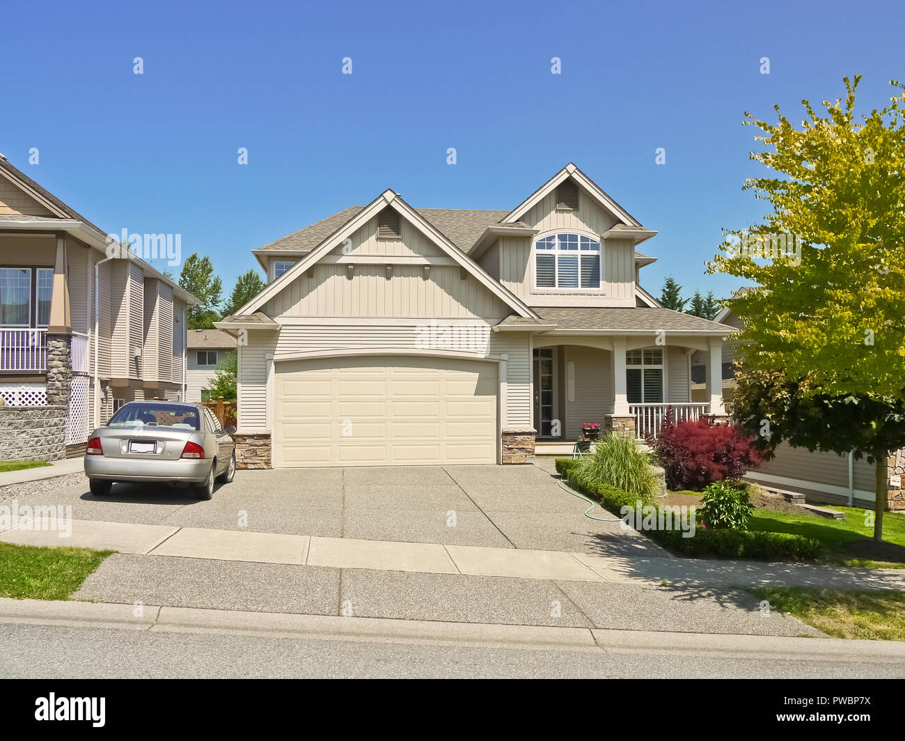 Luxury family house with a car parked on driveway. Residential house on ...