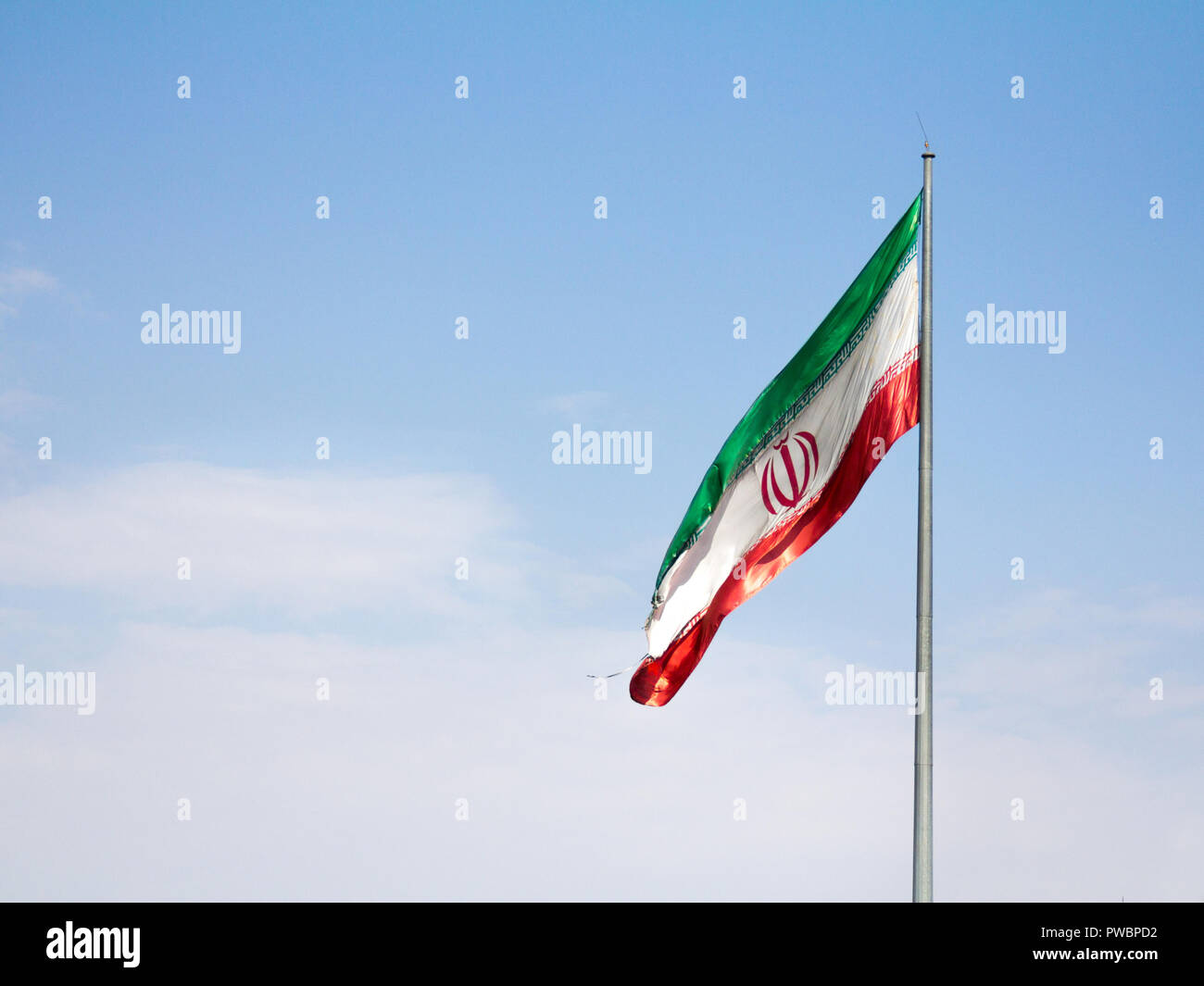 Official flag of the Islamic Republic of Iran waiving in the air in the ...