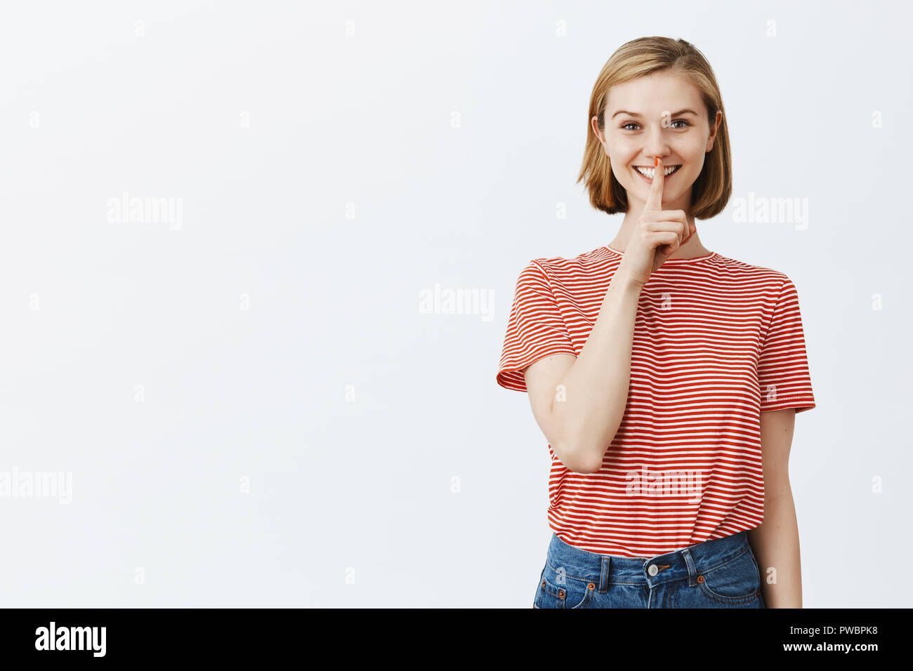 Woman shush smile hi-res stock photography and images - Alamy