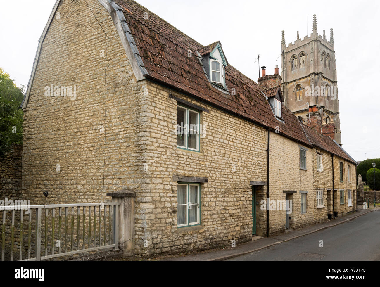 Historic row of cottages and church tower, Calne, Wiltshire, England ...