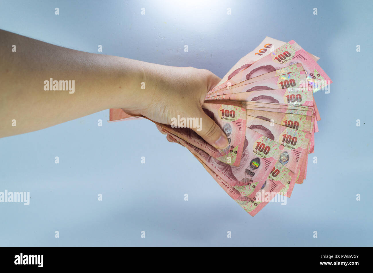 Thai baht banknotes in hand isolated on white background Stock Photo ...