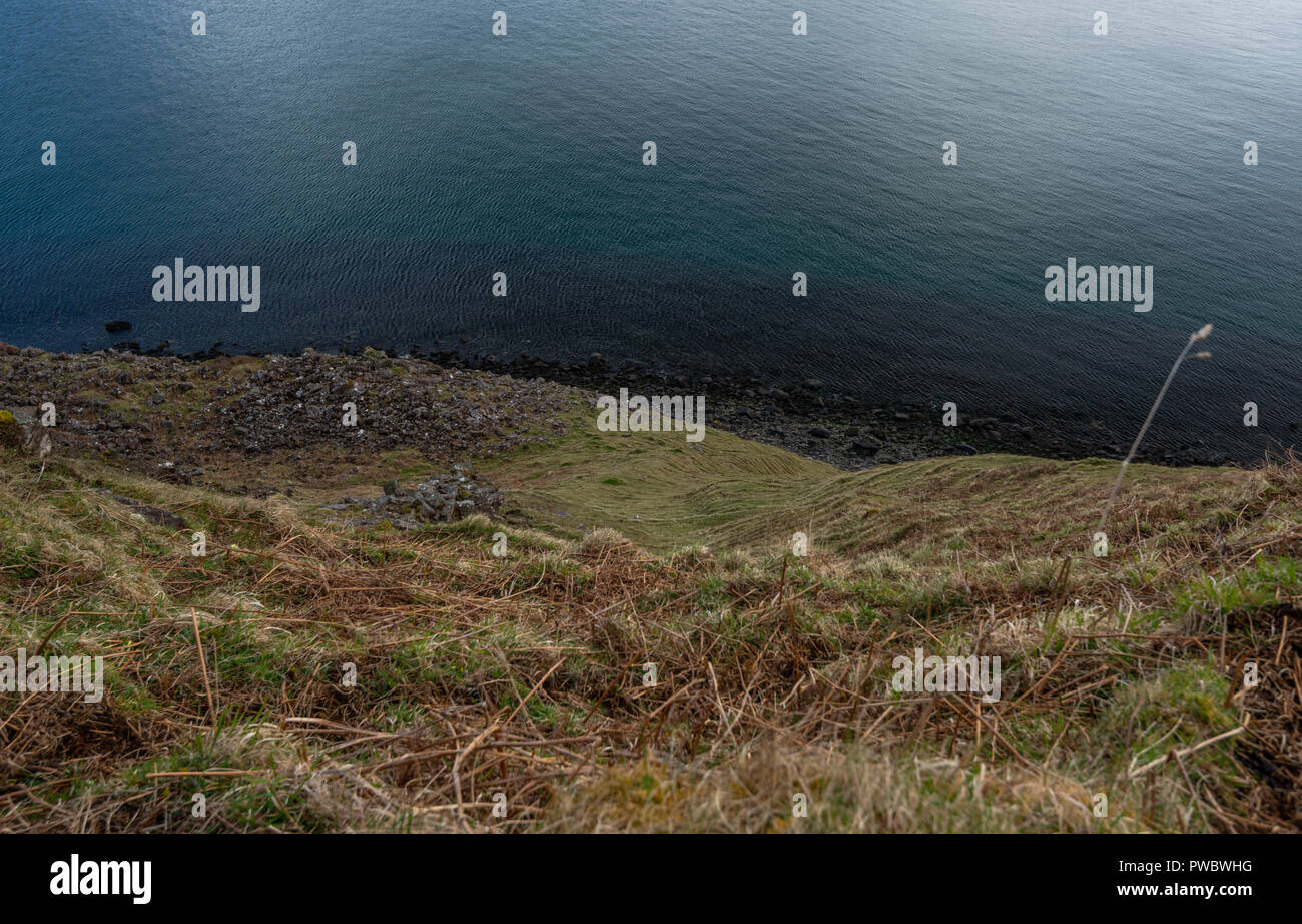 Steep cliffs at the shore near Kilt Rock and the Lealt Falls, Isle of ...