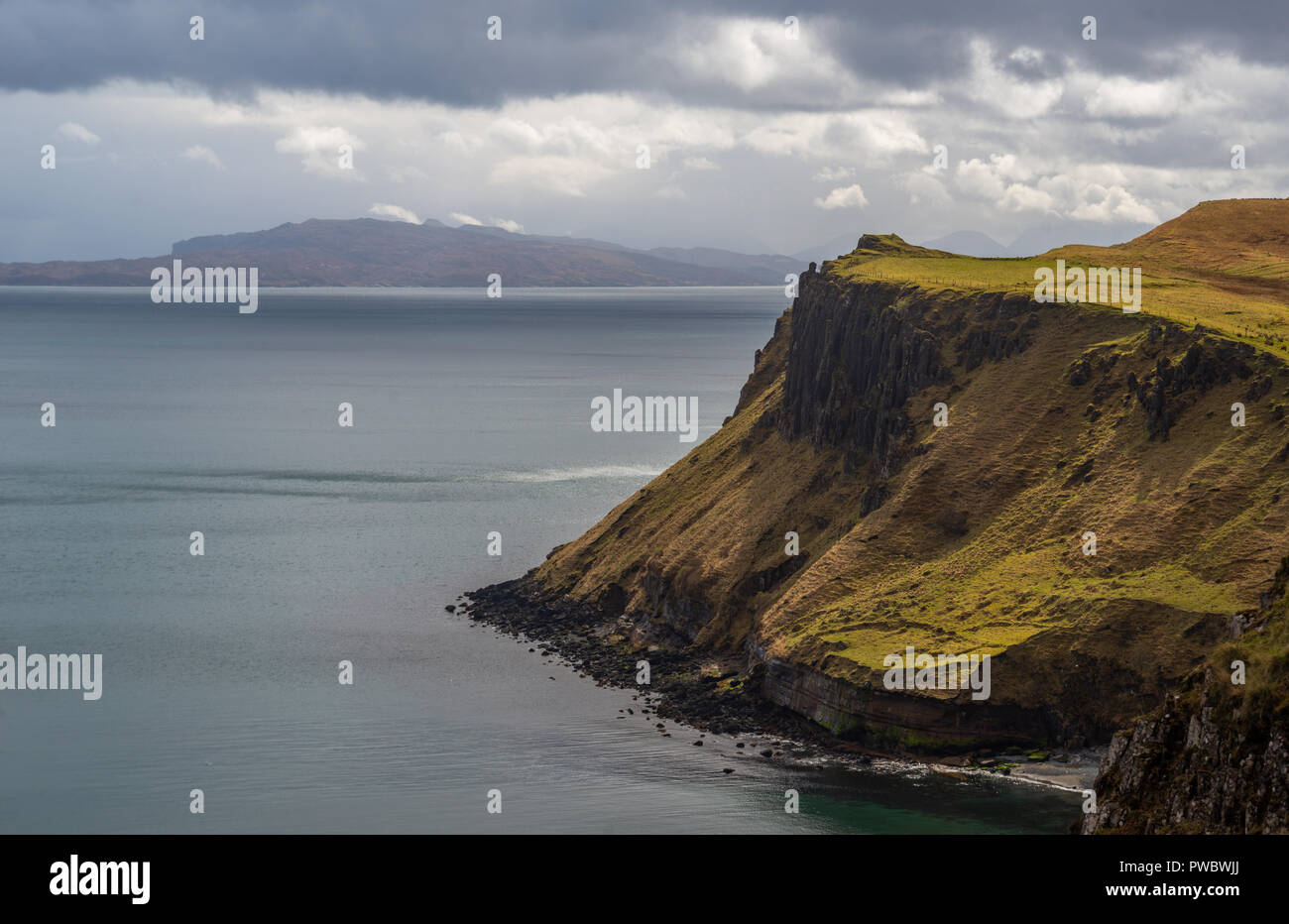 Steep cliffs at the shore near Kilt Rock and the Lealt Falls, Isle of ...