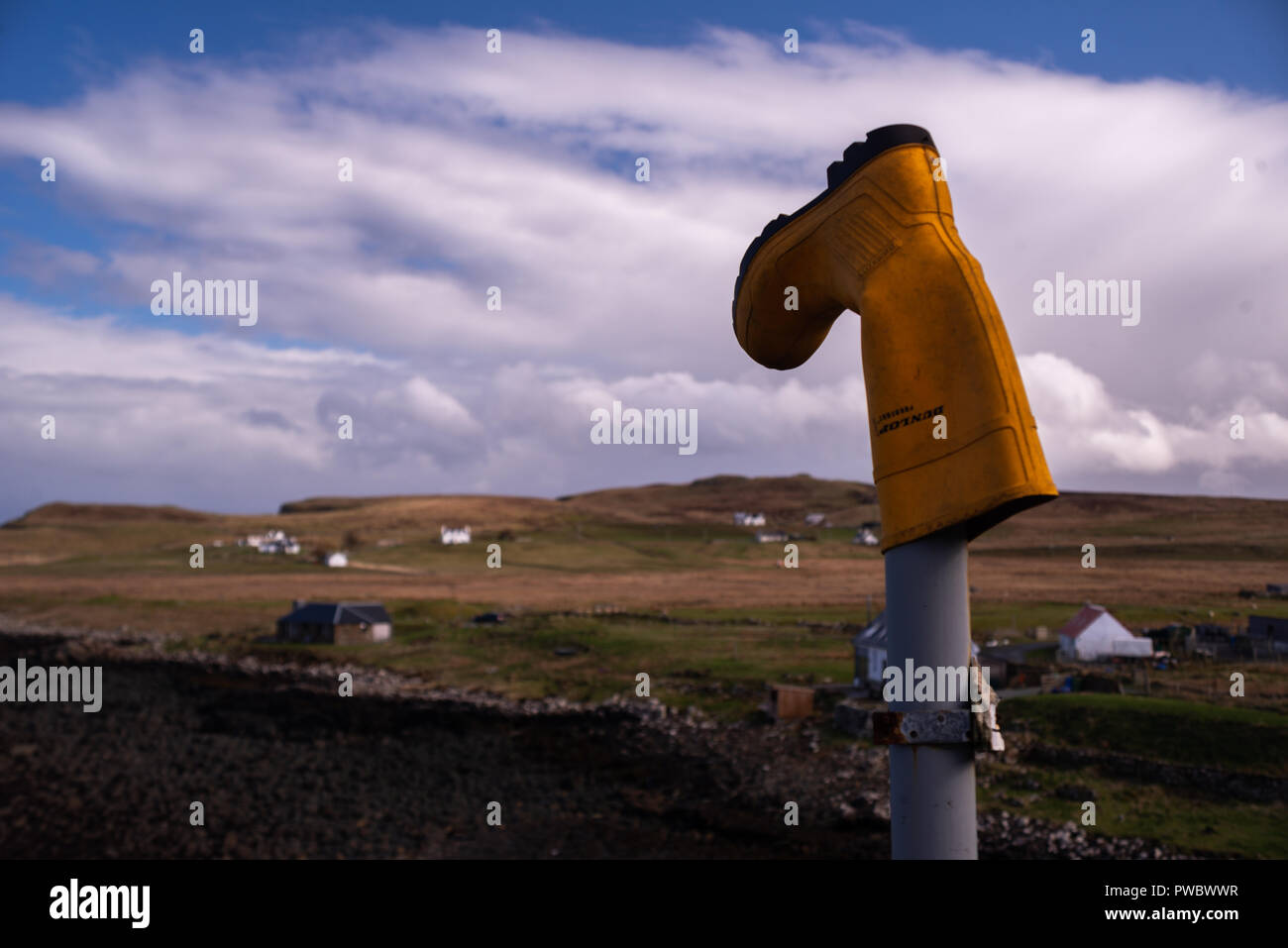 A Yellow rubber boot put on a metal post pillar, Isle of Skye, Scotland ...