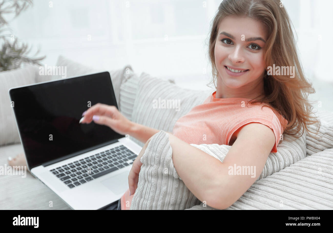 young woman working with laptop sitting on sofa Stock Photo - Alamy