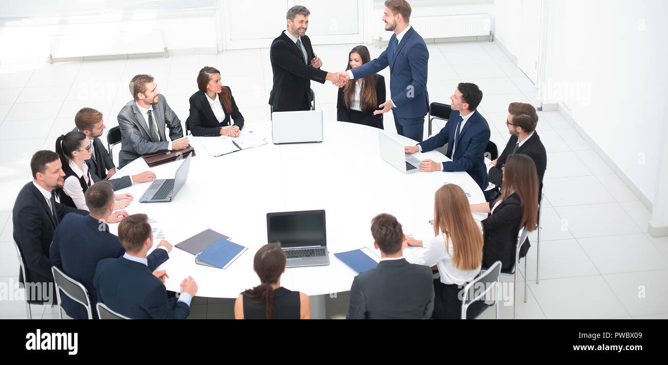 business partners shake hands at the talks near the round table Stock ...