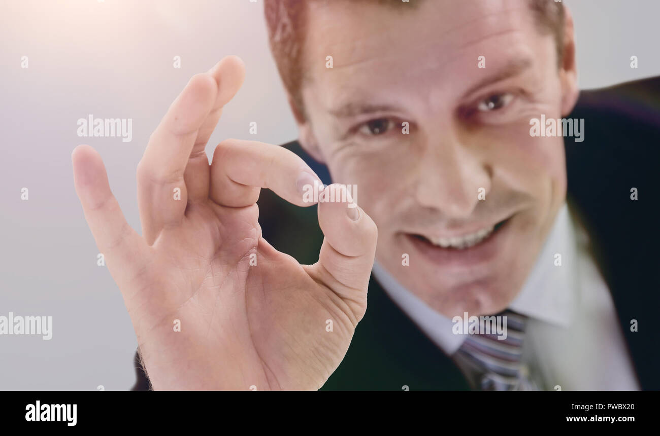Happy young man in suit gesturing OK sign and smiling Stock Photo - Alamy