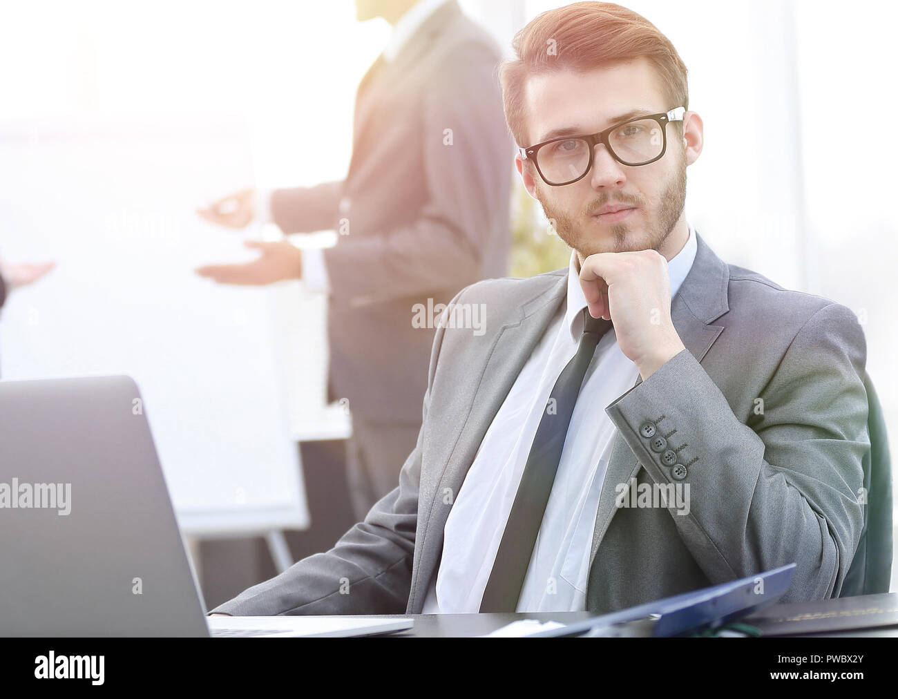 successful businessman sitting at Desk in office Stock Photo - Alamy