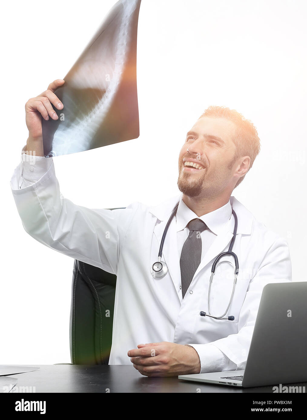 doctor examines an x-ray,sitting behind a Desk Stock Photo - Alamy