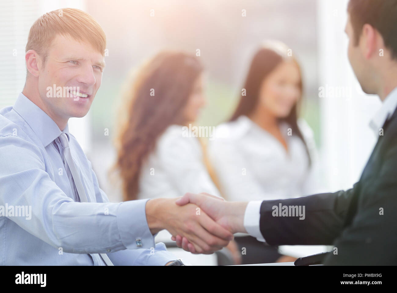 handshake business partners at your Desk Stock Photo - Alamy