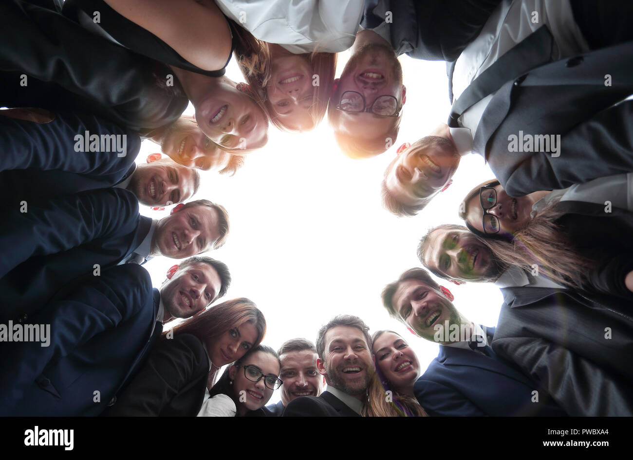 large business team is forming a circle and looking at the camera Stock ...