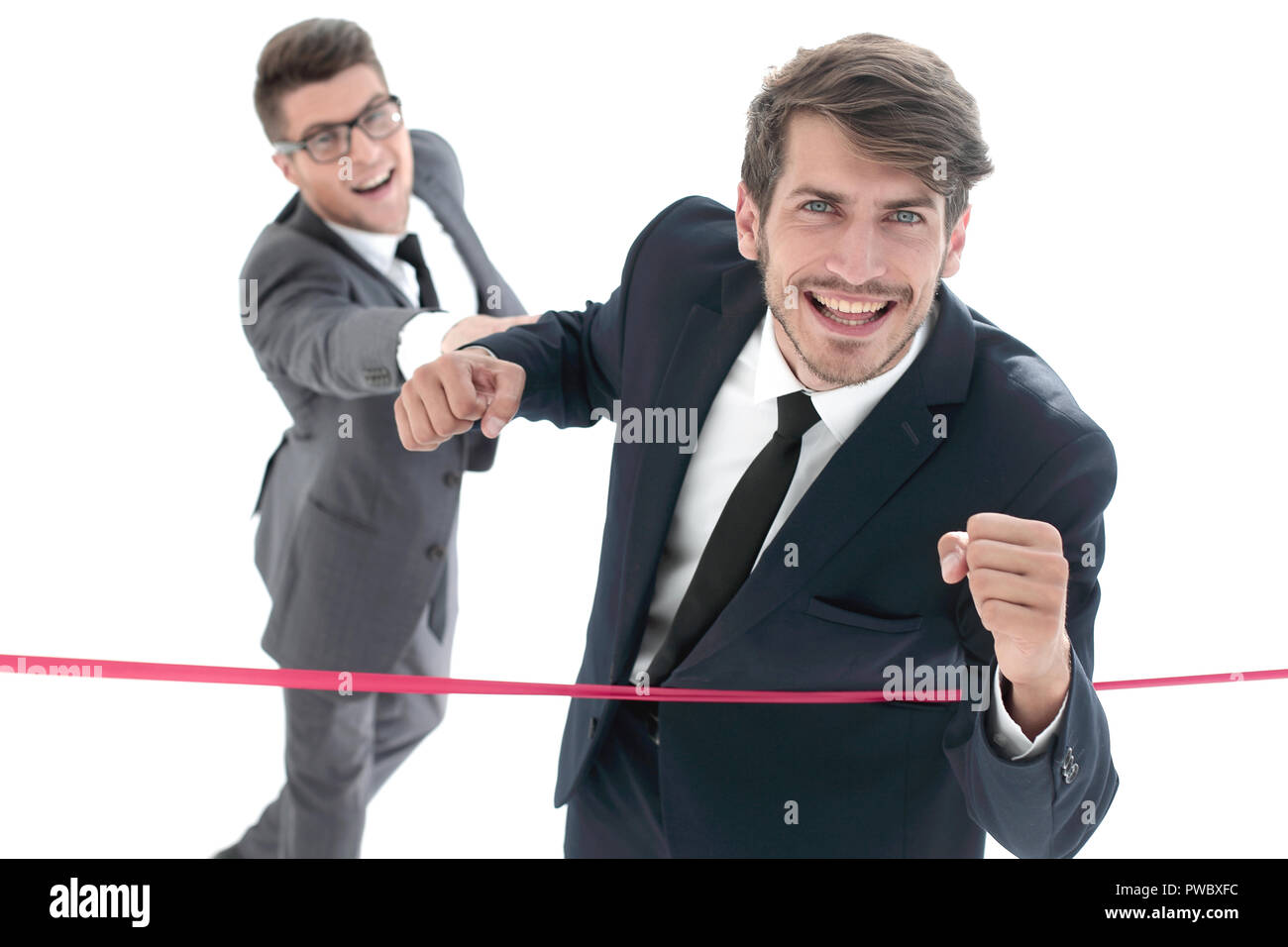 Happy businessman running through finishing line Stock Photo - Alamy
