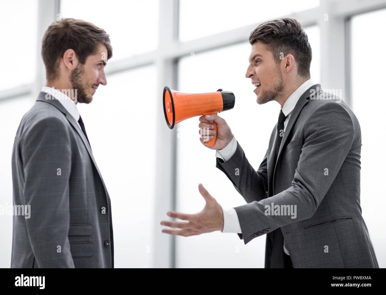 aggressive businessman with megaphone screaming on his coworker Stock ...