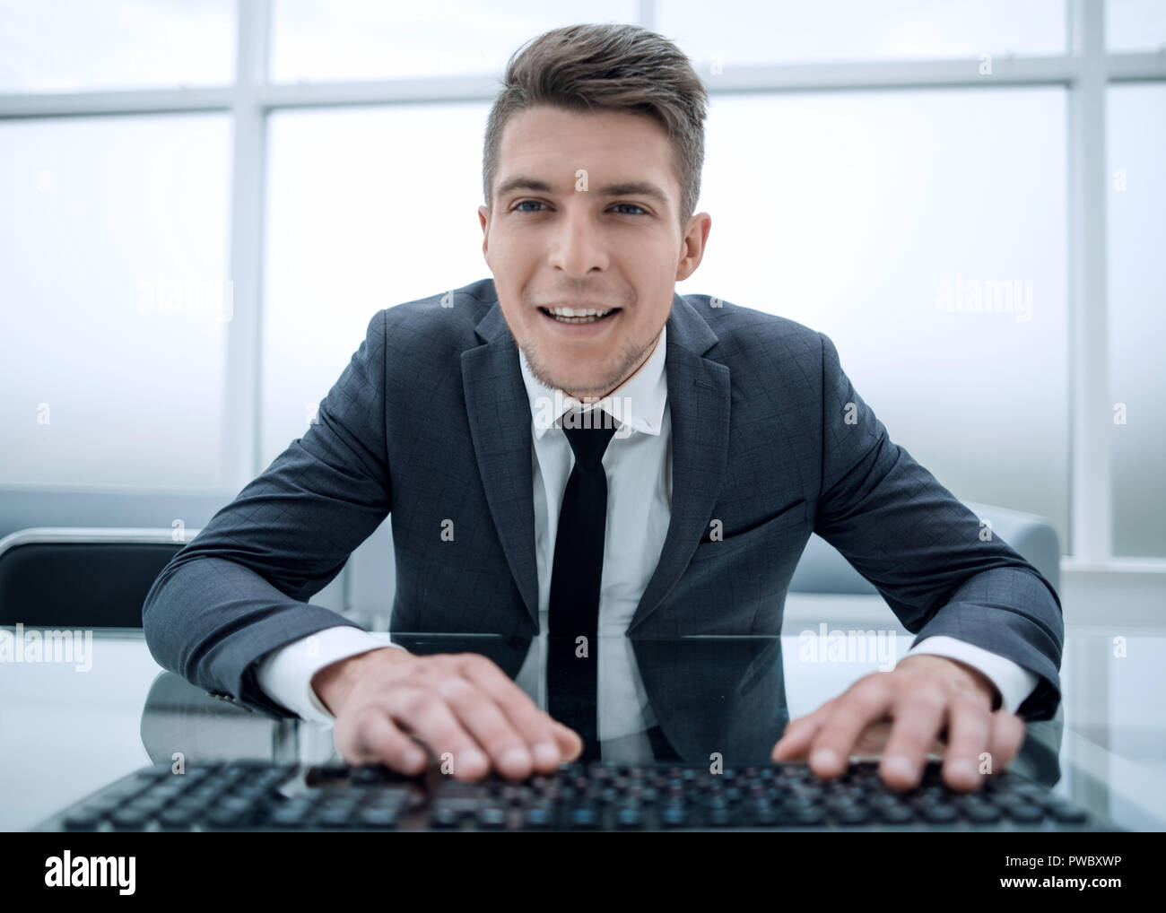 Elegant professional businessman working on computer looking at Stock ...