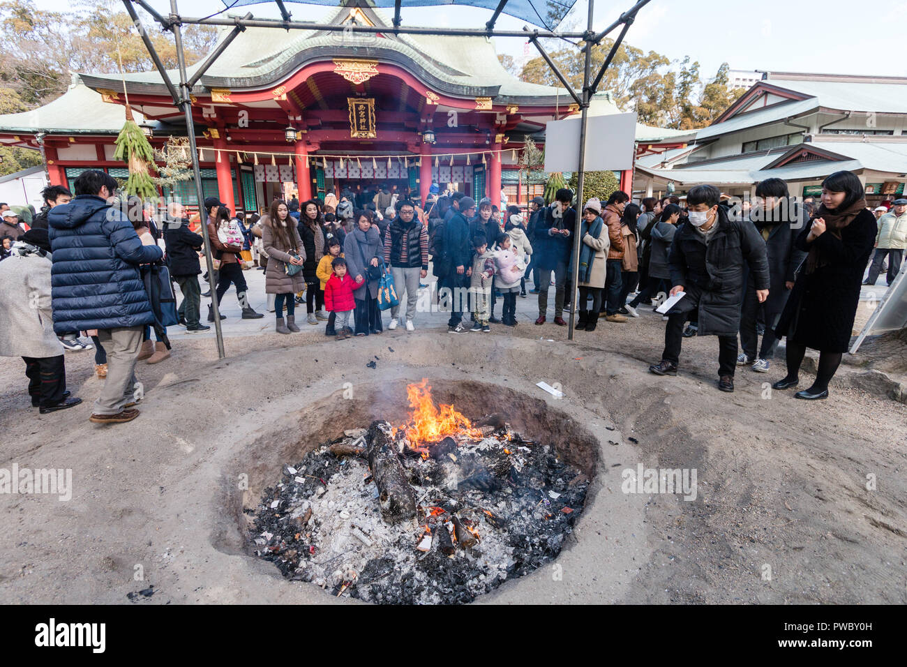 Japanese new year, shogatsu. People praying in front of bonfire used to ...