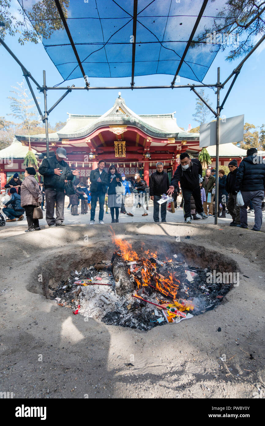 Japanese new year, shogatsu. People praying in front of bonfire used to ...