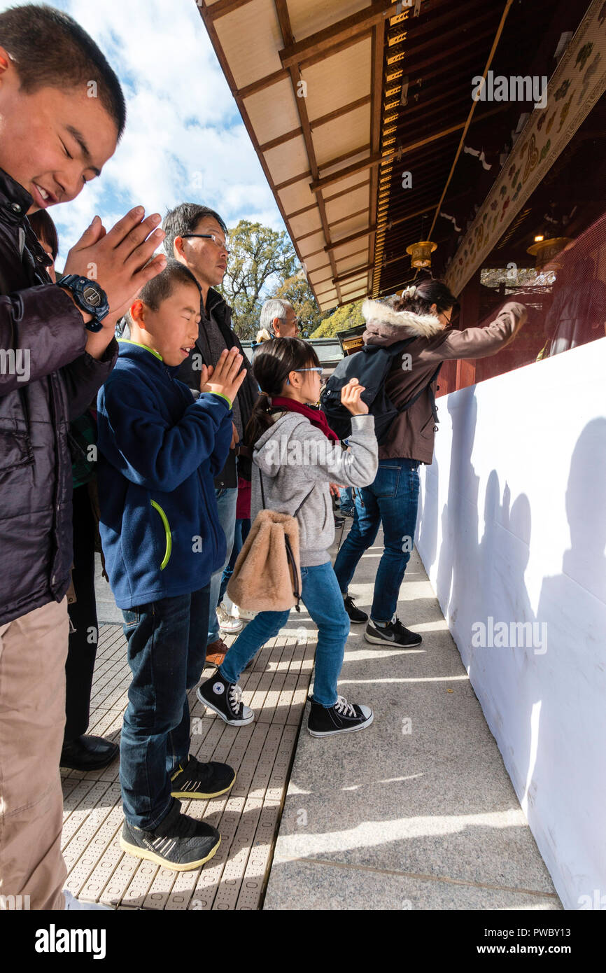 Japanese new year, shogatsu. Two children, boys, with other people ...